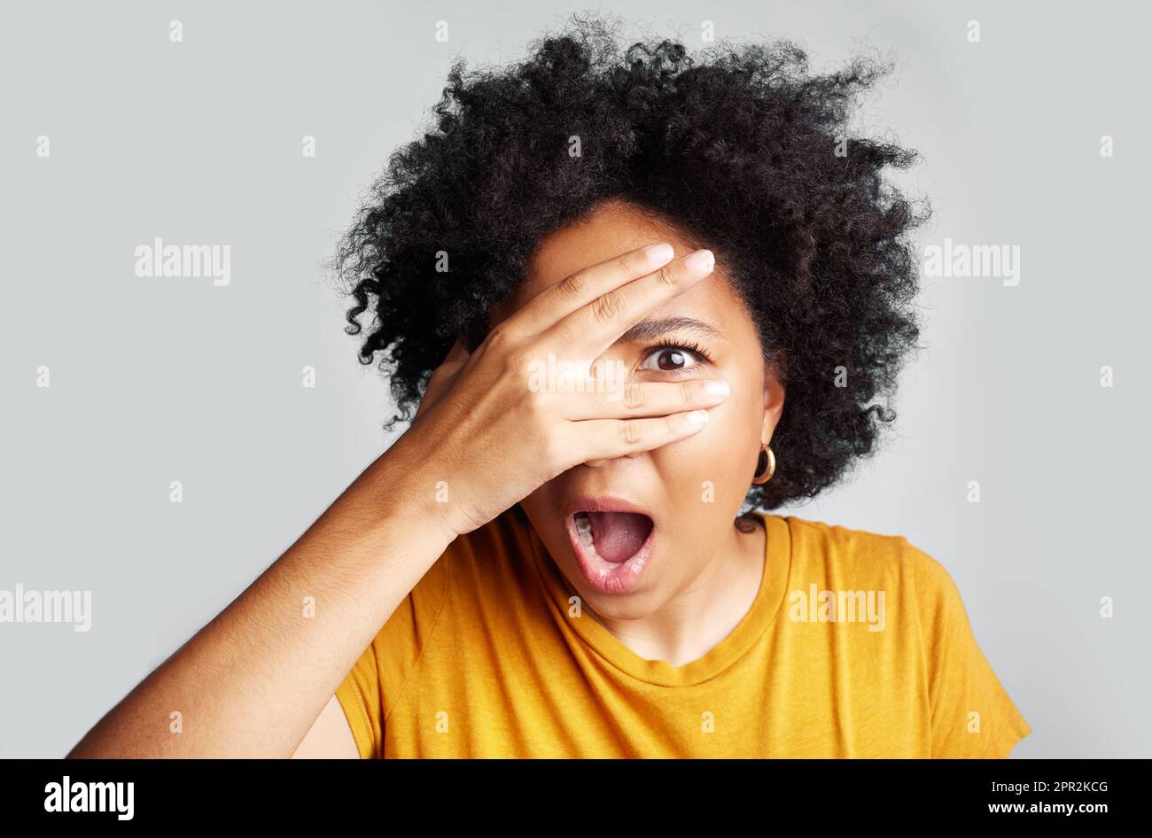 Surprise, wow and woman peeking through hand isolated on a white ...