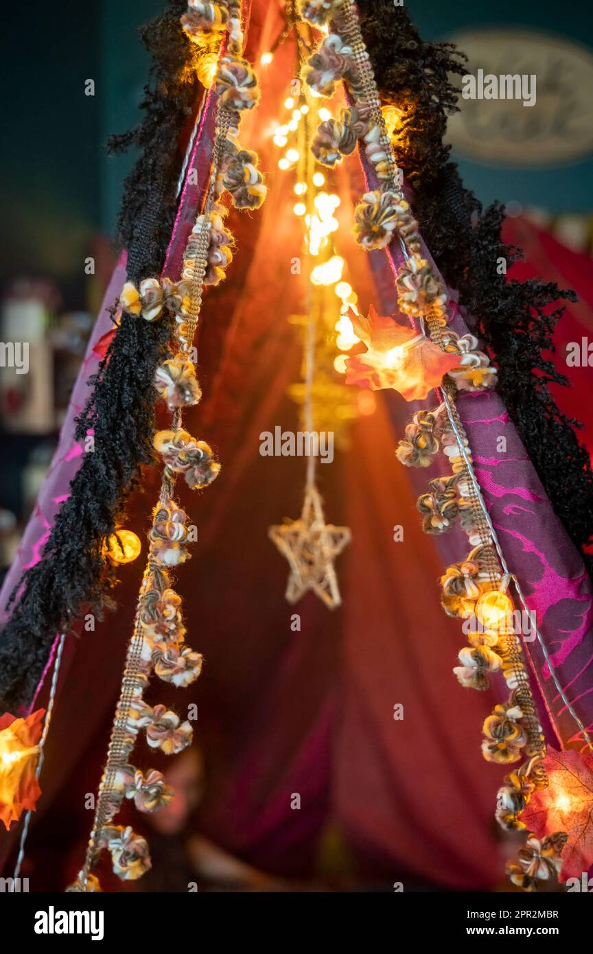 Fortune-teller magically decorated tent with people inside. Lights ...