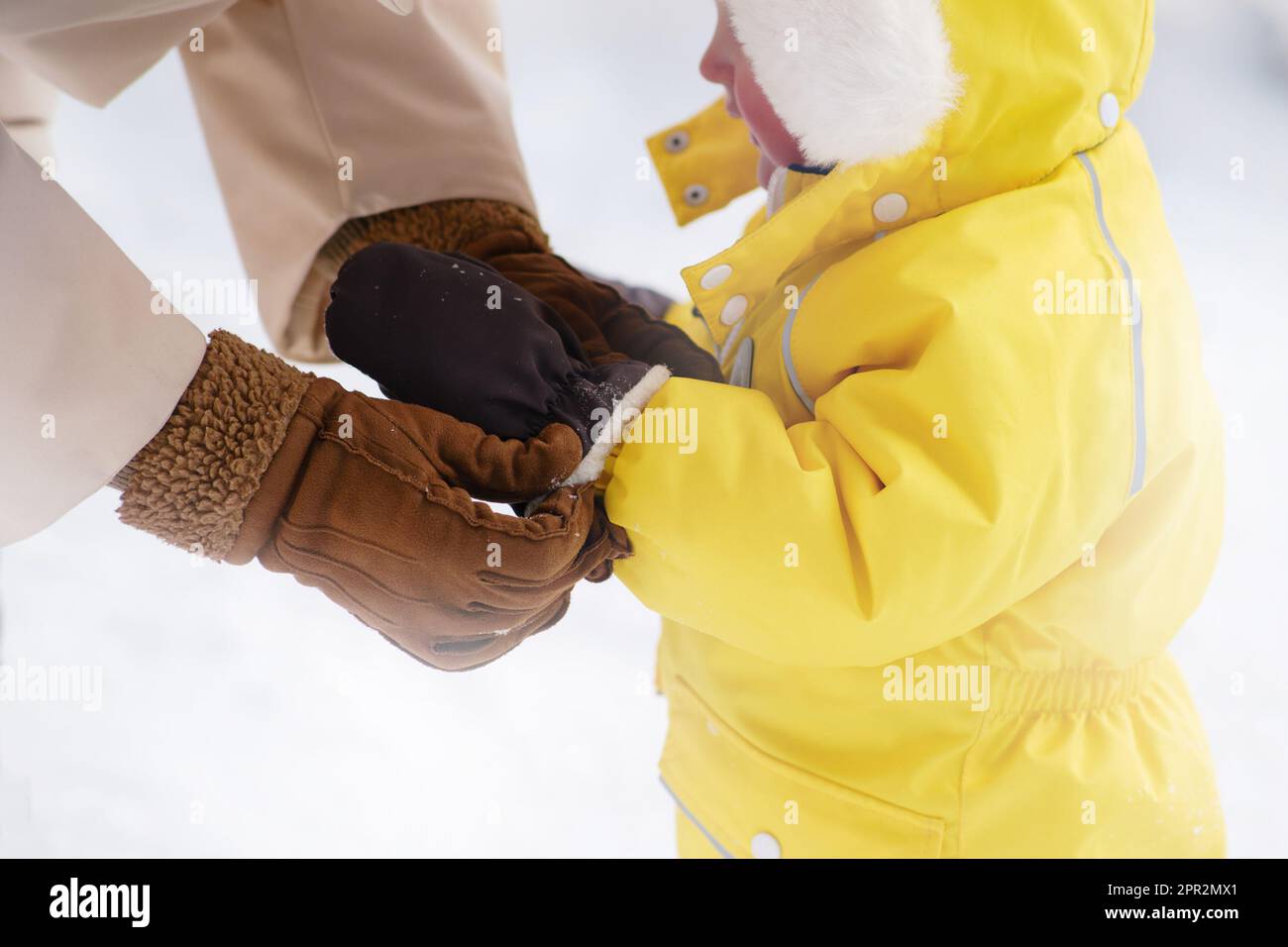 Child helping put on jacket hi-res stock photography and images - Alamy