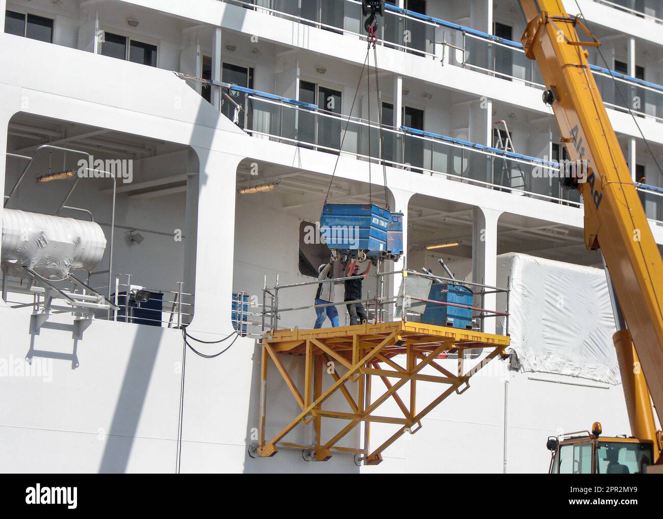 "Chantiers de l'Atlantique" workers operate a dumpster on a cruise ship ...