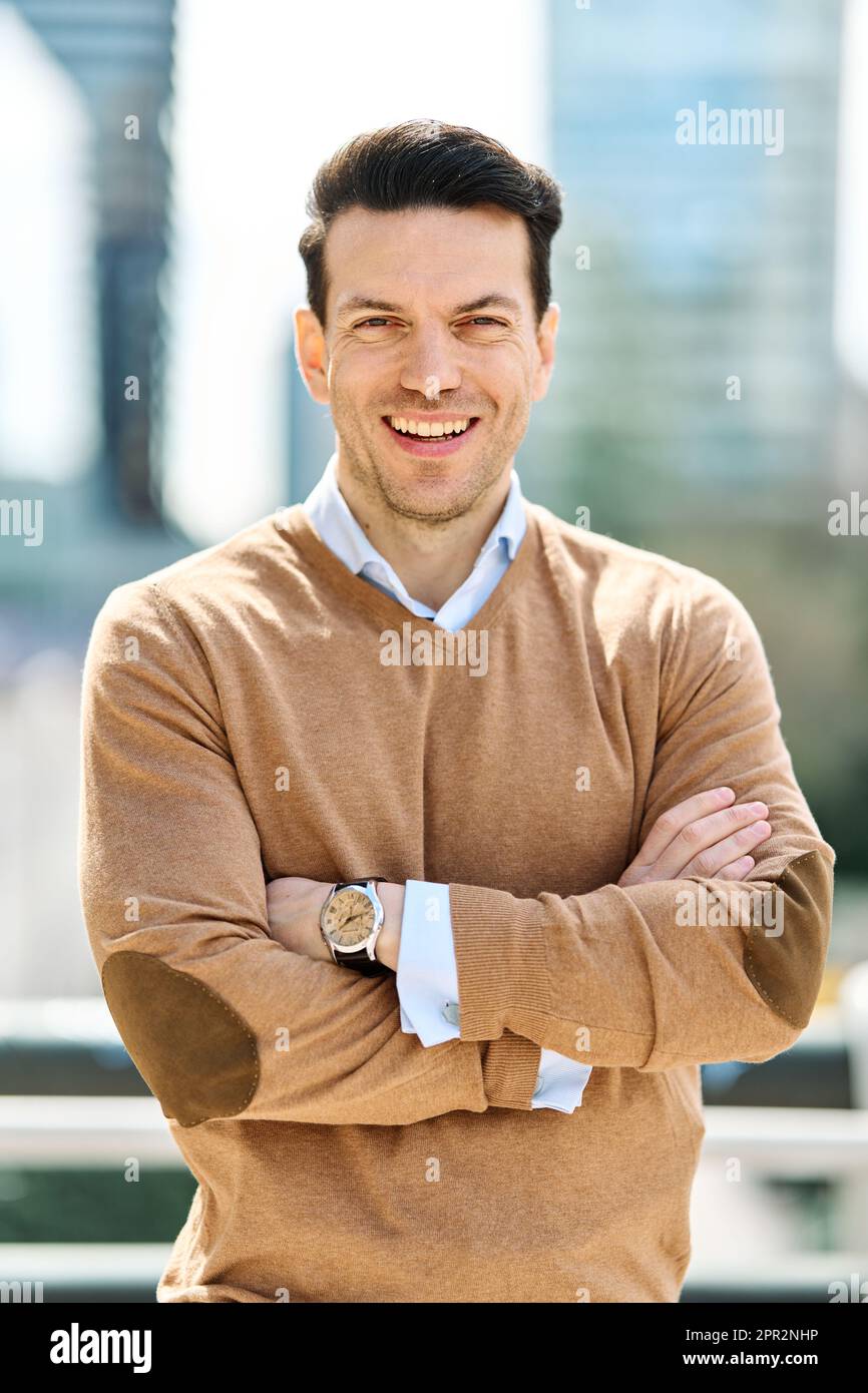 Businessman standing proud with arms crossed outdoors Stock Photo - Alamy