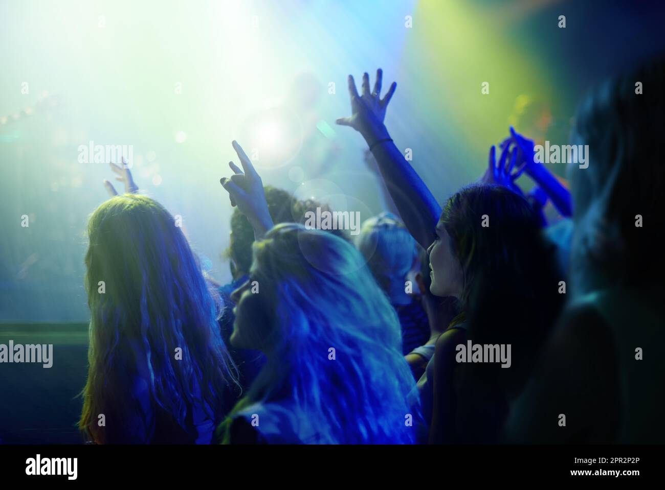 Crowd, neon lights and people at concert or music festival dancing with ...