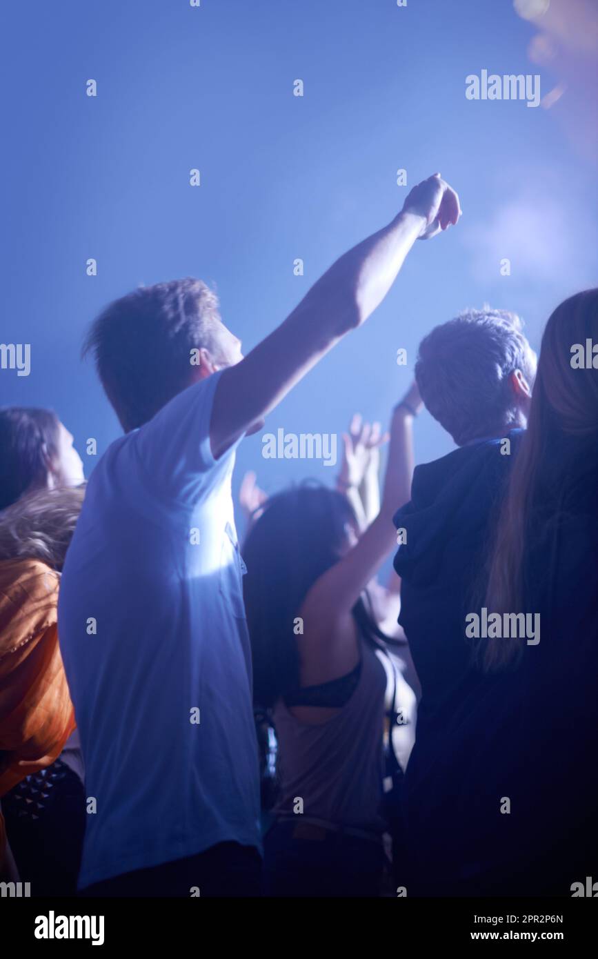 Man in crowd, fans and dancing at concert, music festival and hands in ...