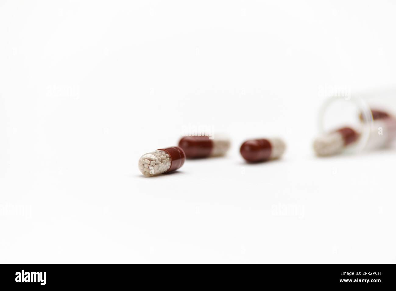 Details on foreground with one translucent capsule with enteric ...