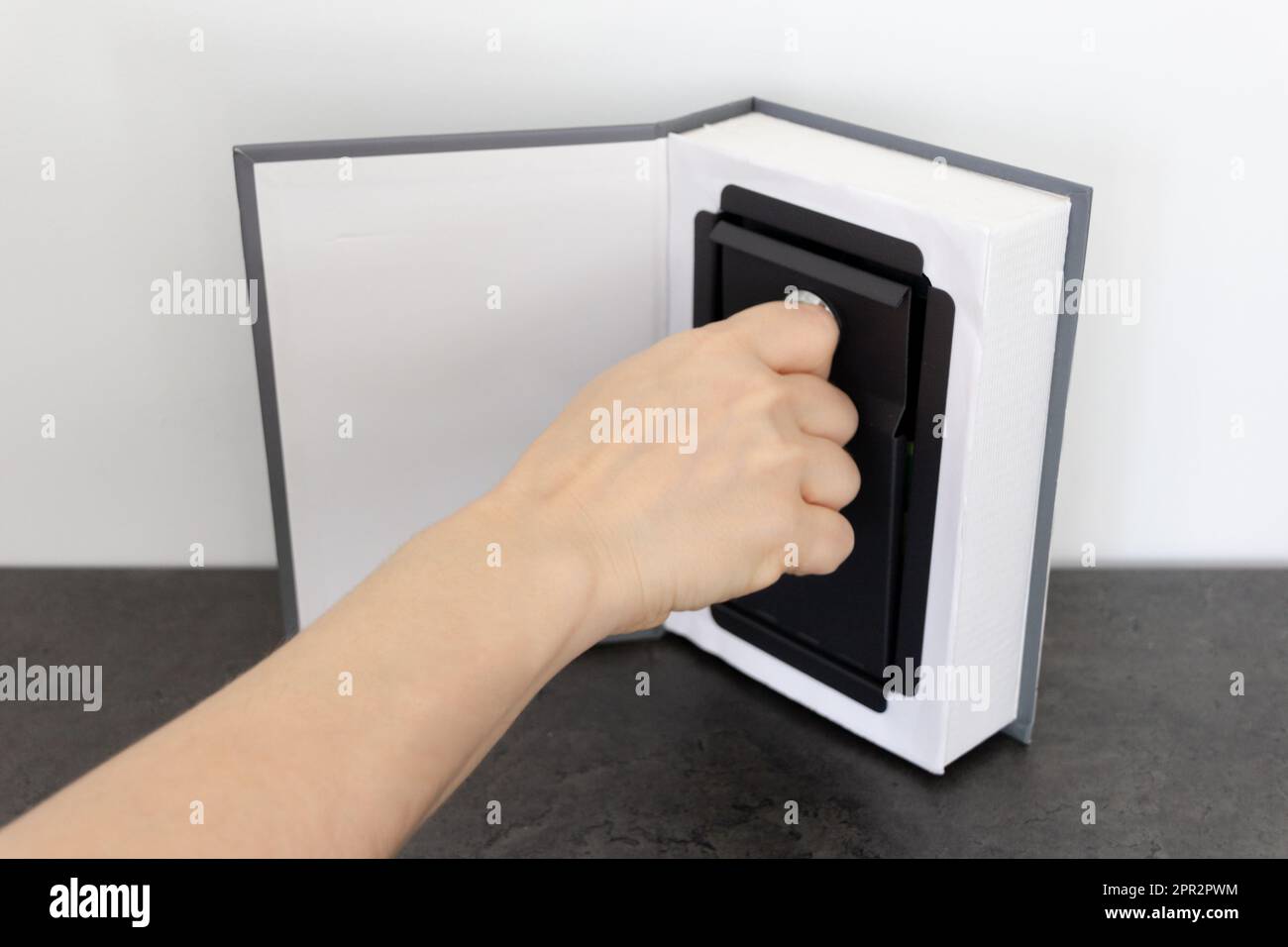 A hand is seen opening or closing a secure safe box - the perfect image ...
