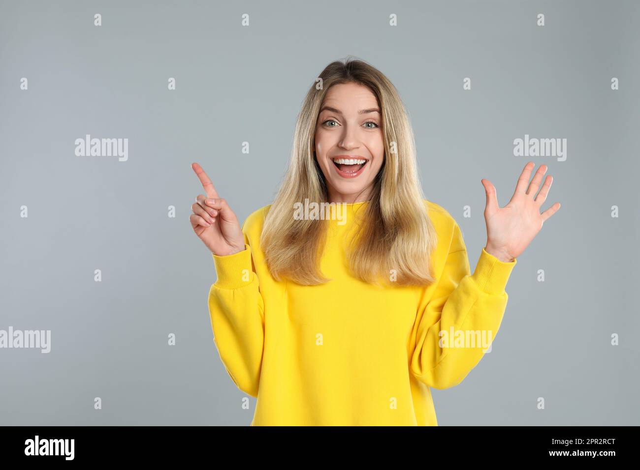 Woman showing number six with her hands on light grey background Stock ...