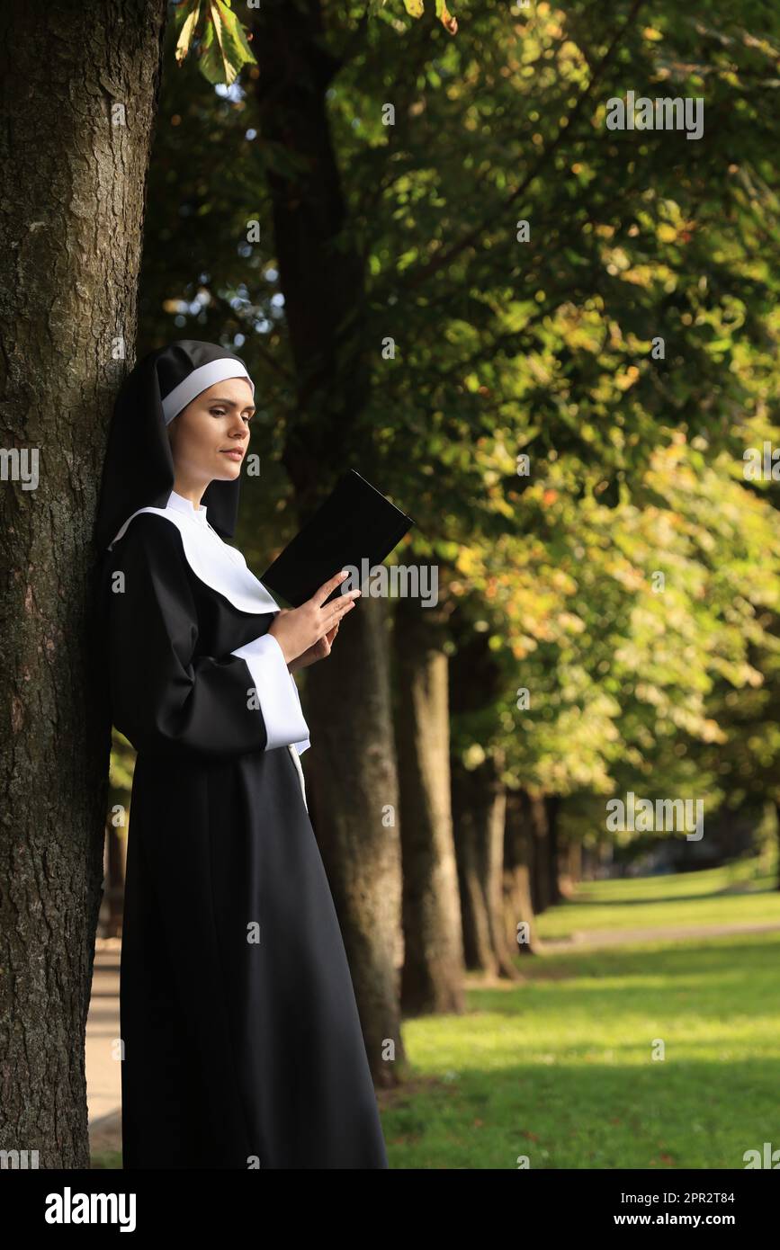 Young nun reading bible hi-res stock photography and images - Alamy