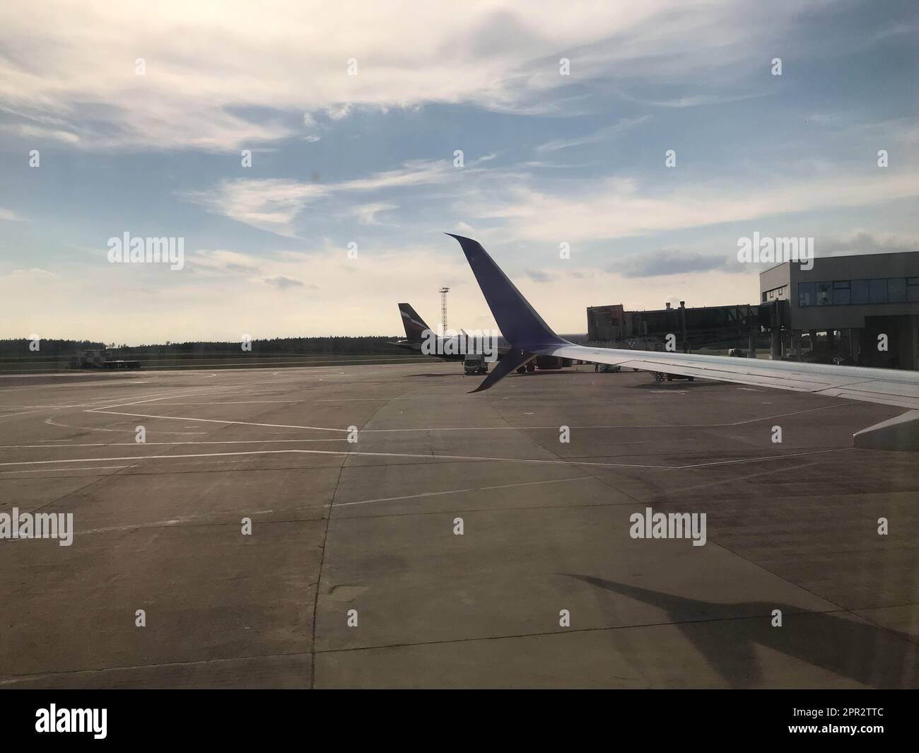 view on the wing from the window of a plane above runway Stock Photo ...
