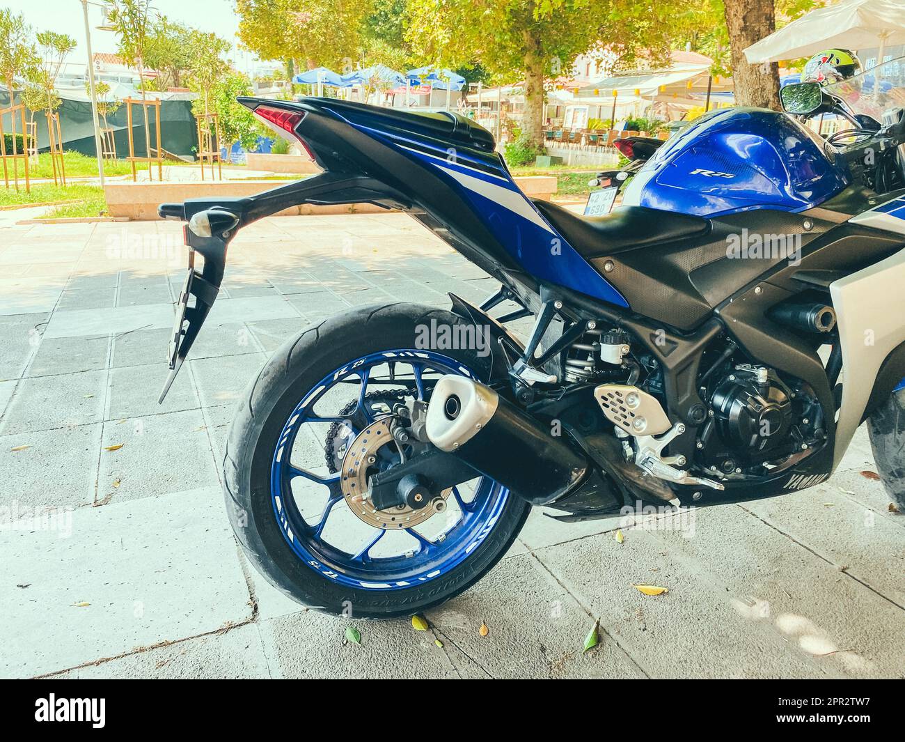 blue motorcycle stands on the beach. means of transportation in the ...