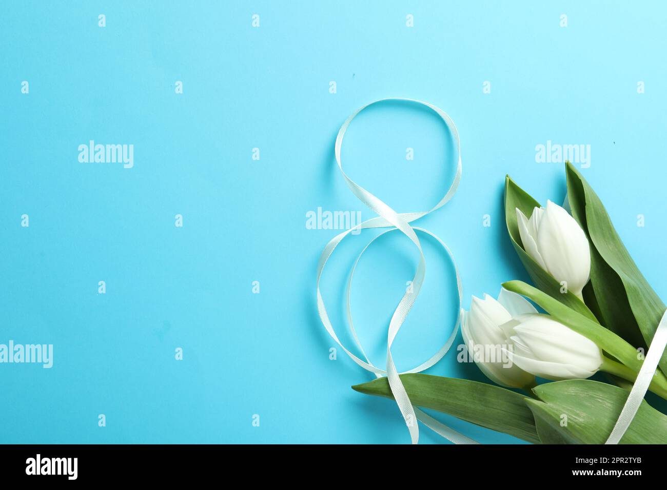 8 March card design with tulips and space for text on light blue ...