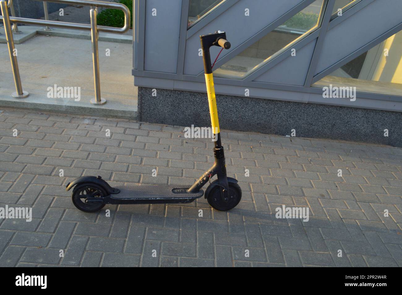 bright yellow electric scooter on small wheels for people to ride ...