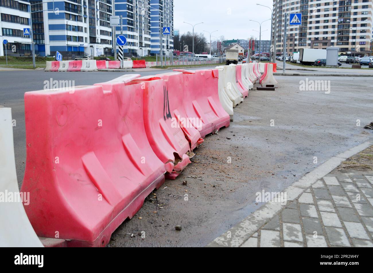 Large plastic red and white enclosure blocks filled with water for road ...