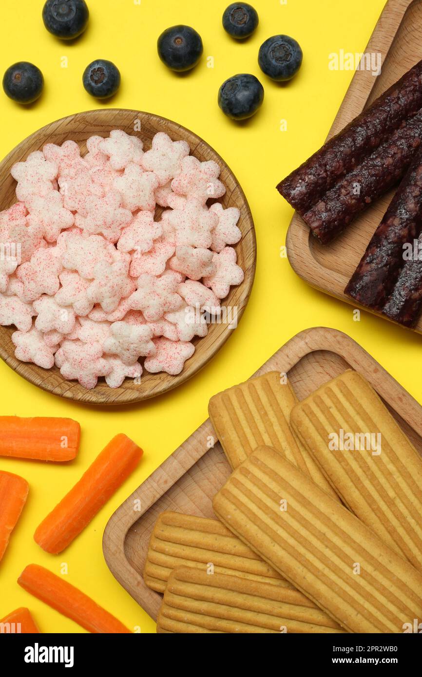 Different finger foods for baby on yellow background, flat lay Stock ...