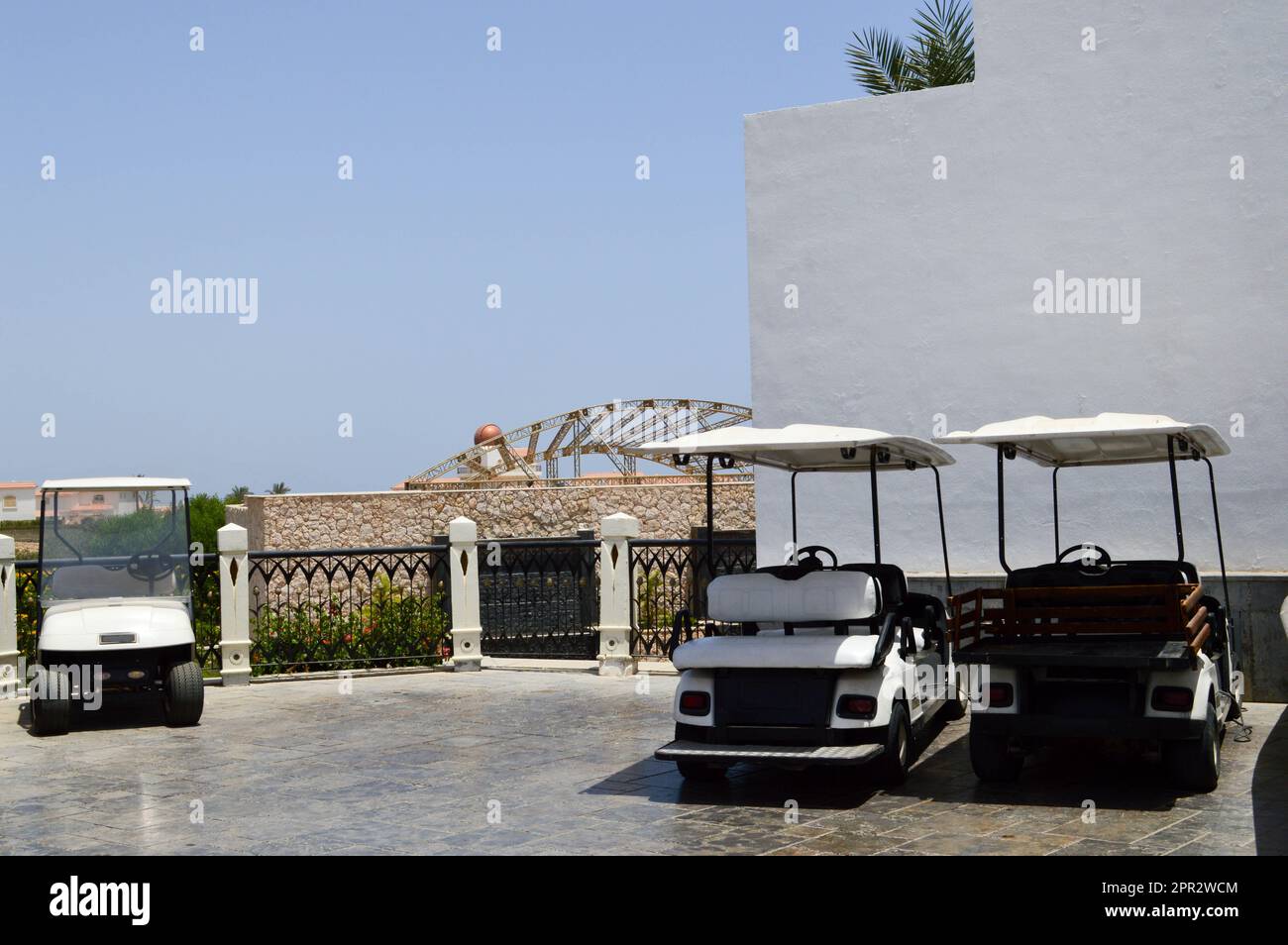 White electric golf cars are parked in small electric vehicles with ...