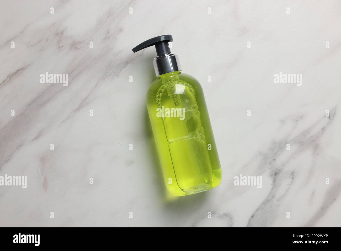Dispenser of liquid soap on white marble table, top view Stock Photo ...