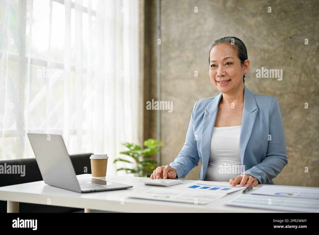 Attractive and confident senior businesswoman or female CEO in formal ...