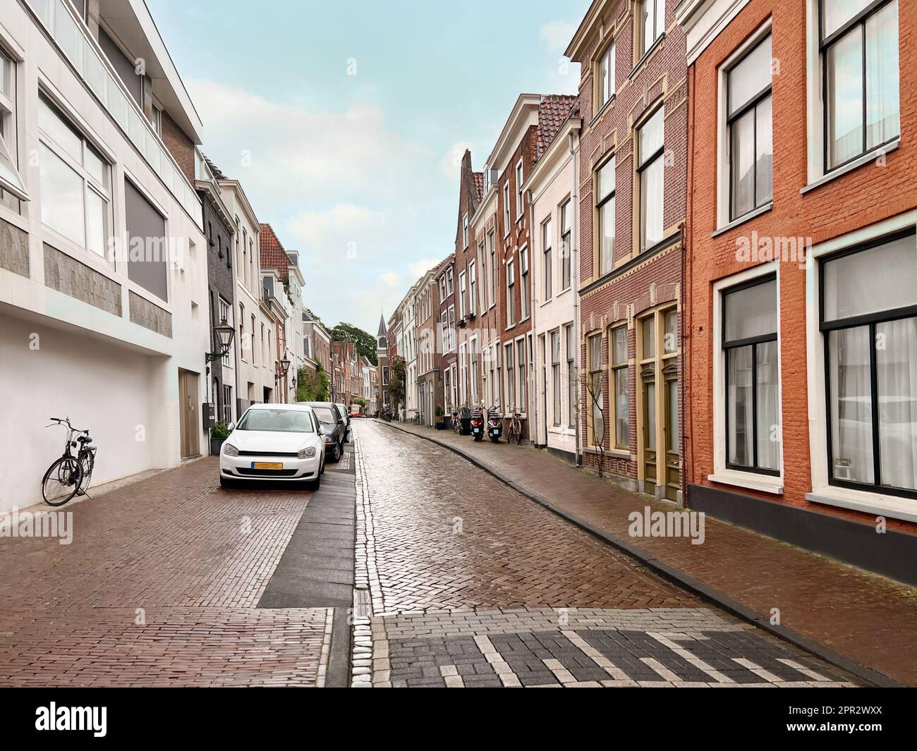 Picturesque view of city street with beautiful buildings and parked ...