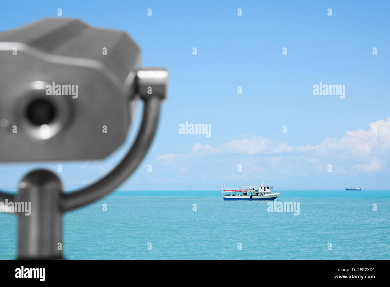 Metal tower viewer and picturesque view of sea with boat. Mounted ...
