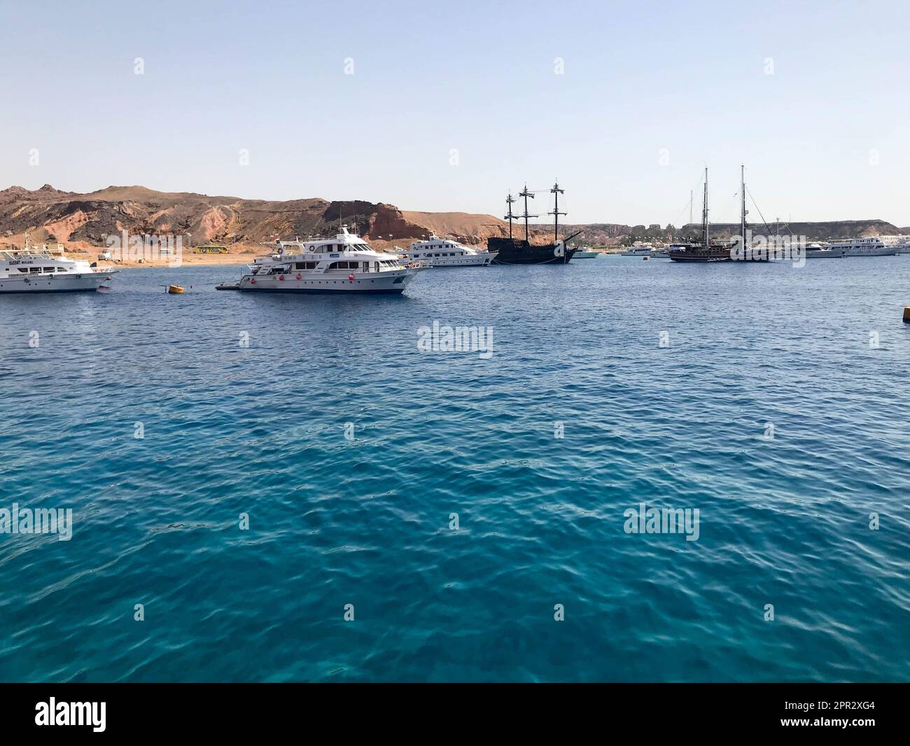 A lot of various motor and sailing ships stand on the quay in the port ...