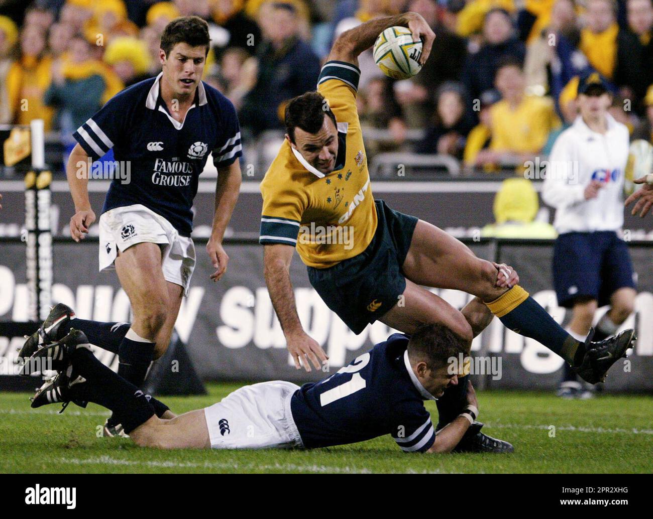 FILE - Australian fullback Joe Roff, center, is tackled by Scotland's ...