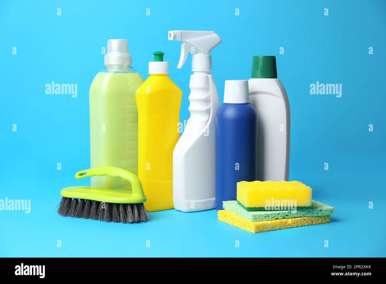 Cleaning supplies and tools on light blue background Stock Photo - Alamy