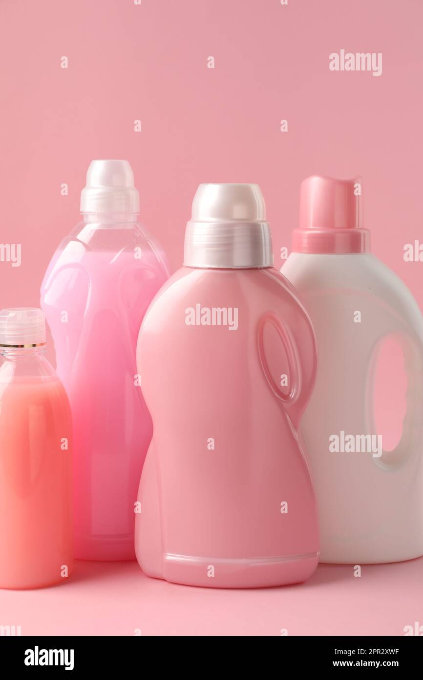 Bottles of laundry detergents on pink background Stock Photo - Alamy
