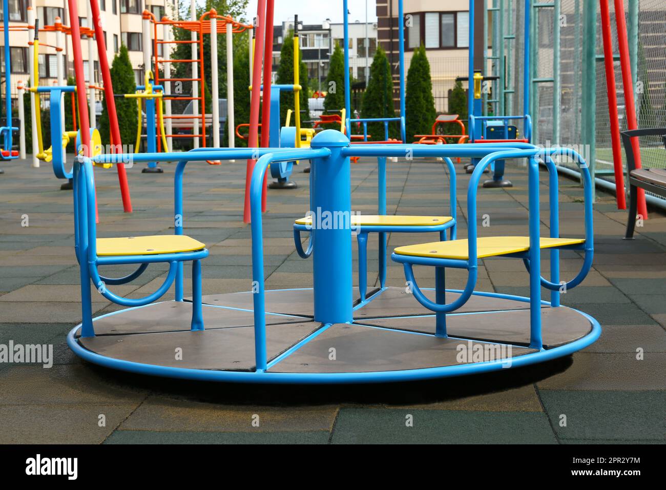 Empty outdoor children's playground with merry-go-round in residential ...