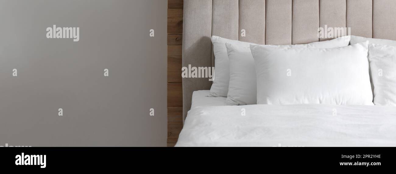 Bed with soft pillows in room, space for text. Banner design Stock ...