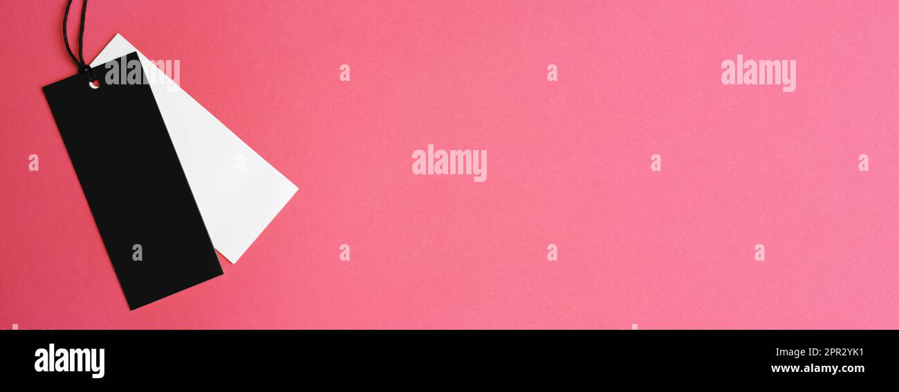 Blank tags on pink background, top view with space for text. Banner ...