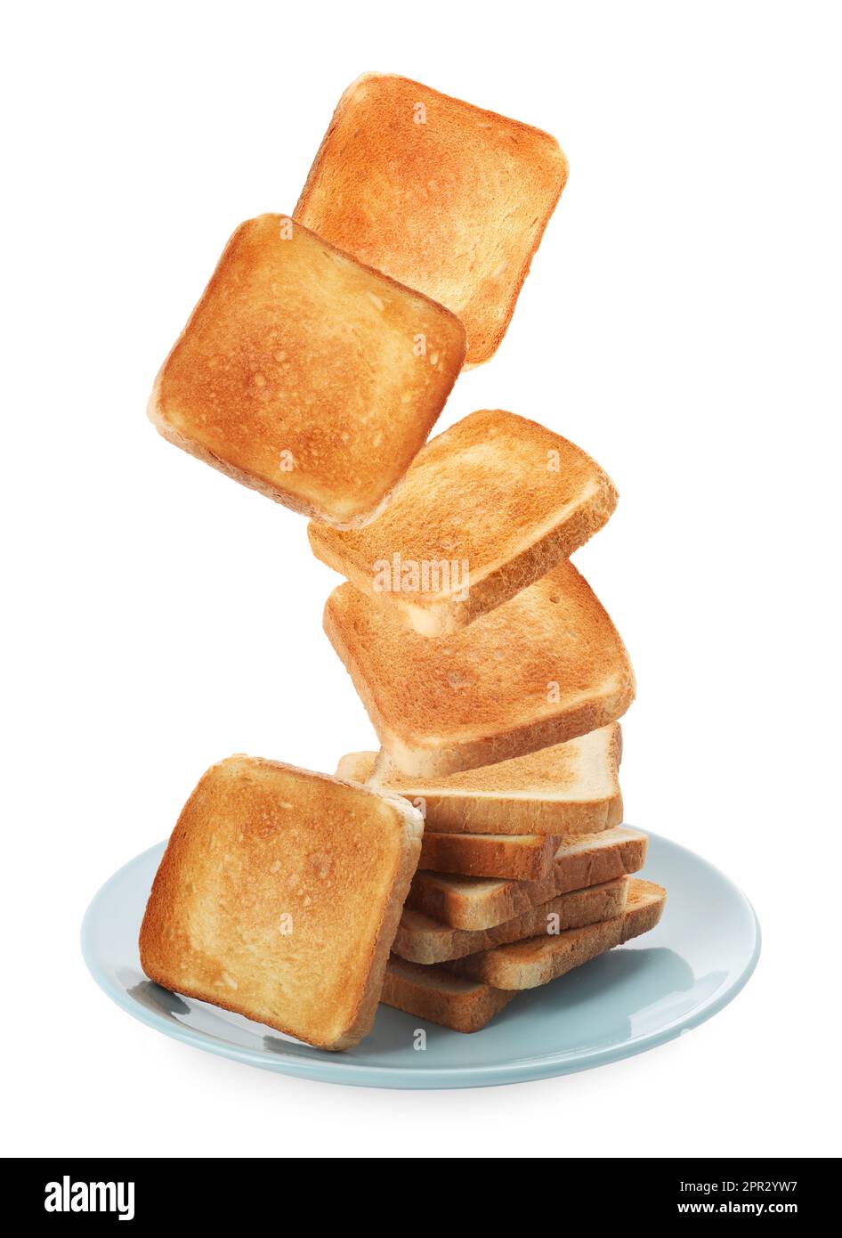 Delicious toasted bread falling into plate on white background Stock ...
