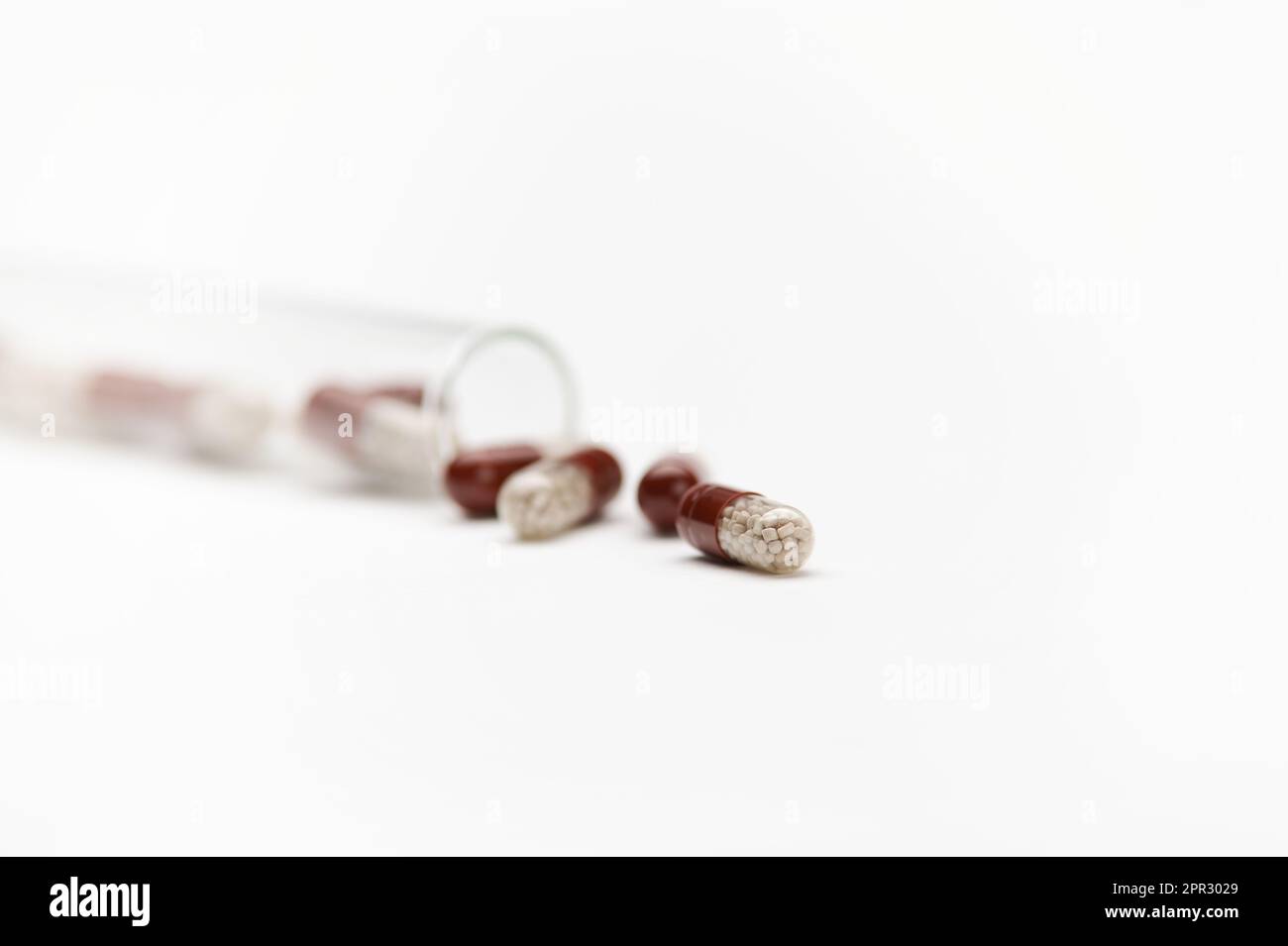 Still life with translucent gel capsules containing enteric granules ...