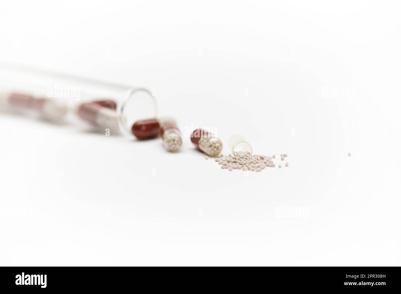 Selective focus: enteric capsules spilling out from gel translucent ...