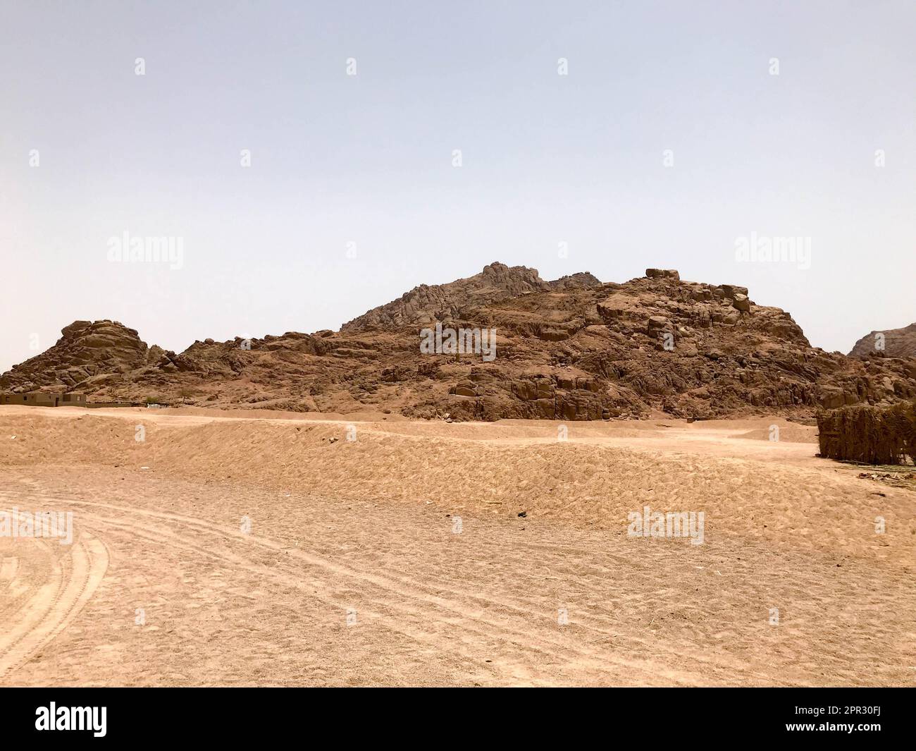 A large high stone sandy mountain in the desert with sand background ...