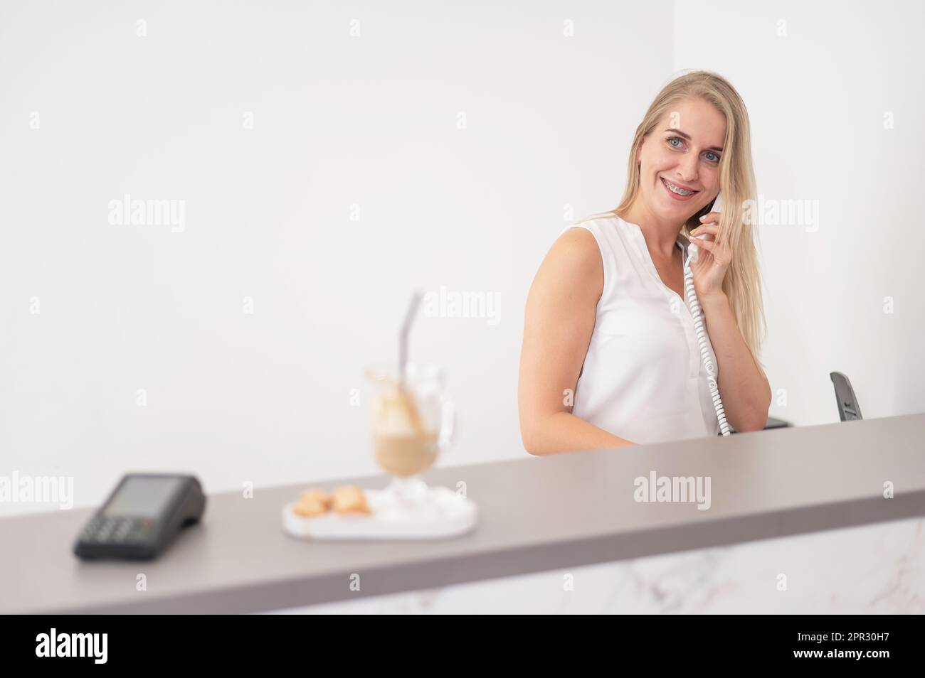 Salon receptionist phone hi-res stock photography and images - Alamy