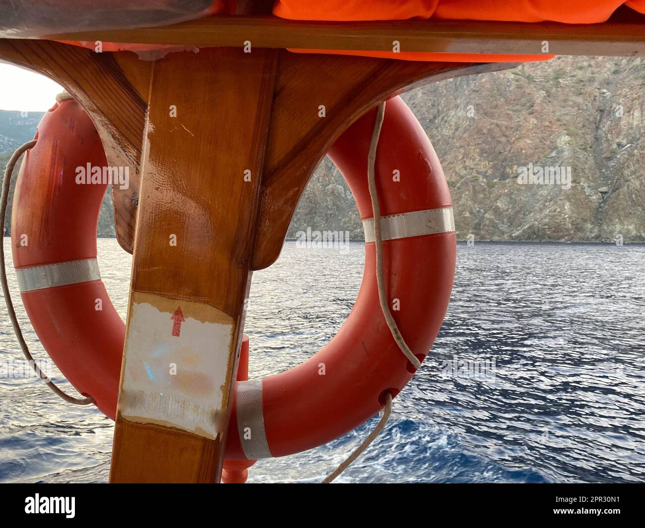 Red Life buoy in front of the blue sea and the white ship Stock Photo ...