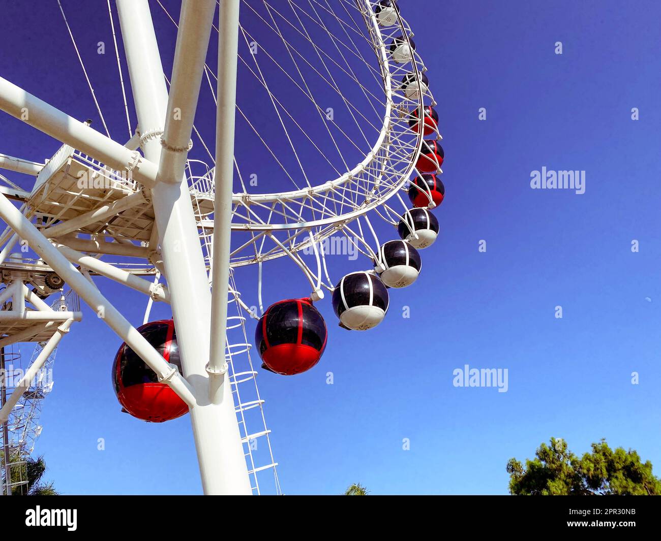 Ferris wheel in the city against the blue sky. carousel for riding ...
