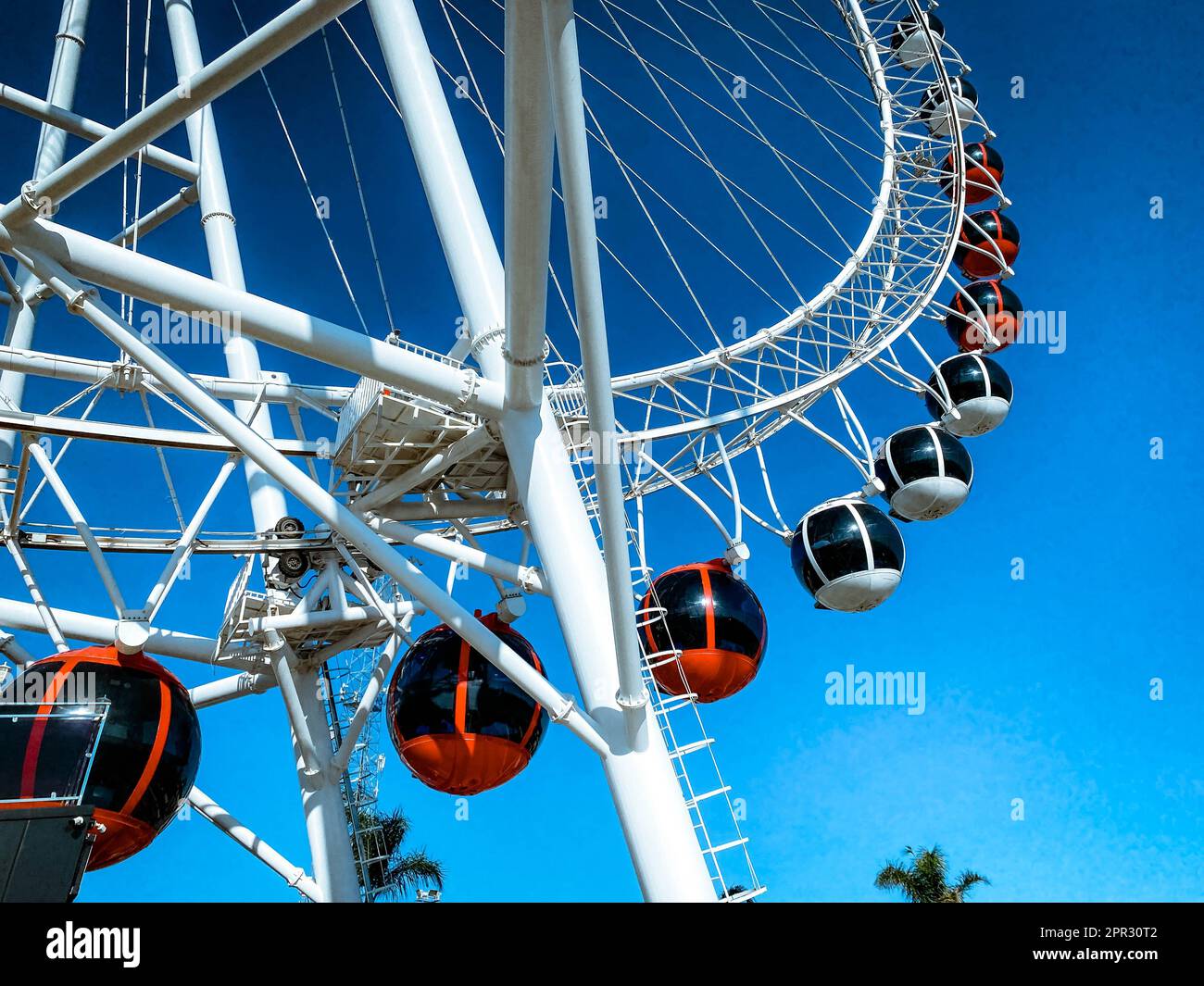 Ferris wheel in the city against the blue sky. carousel for riding ...