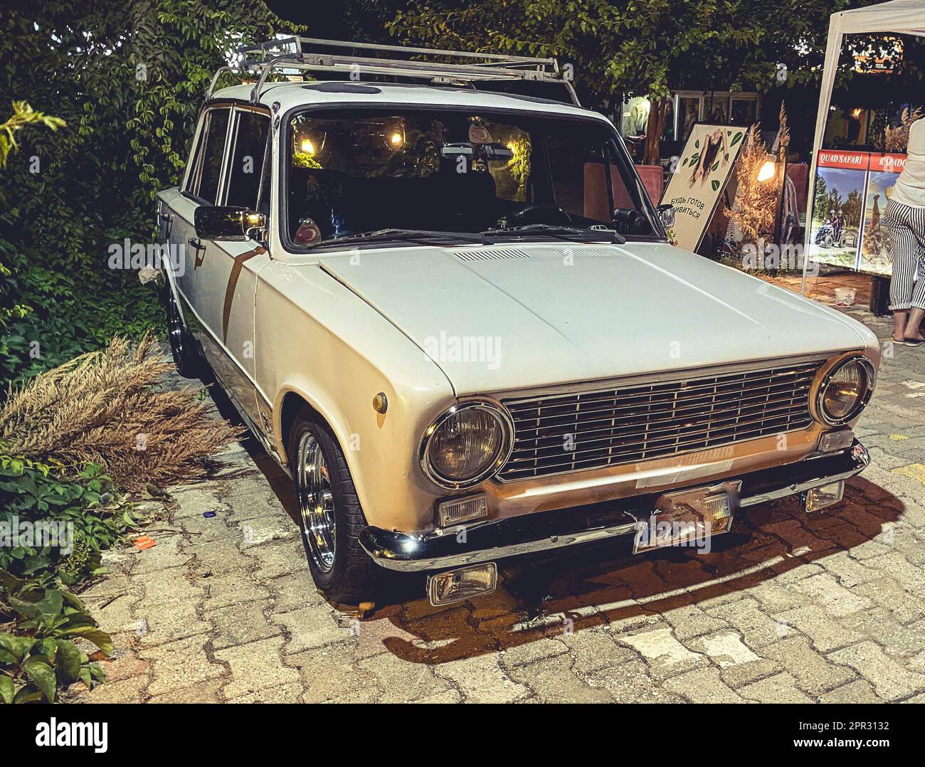 an old, white retro car stands on the street like a museum piece ...