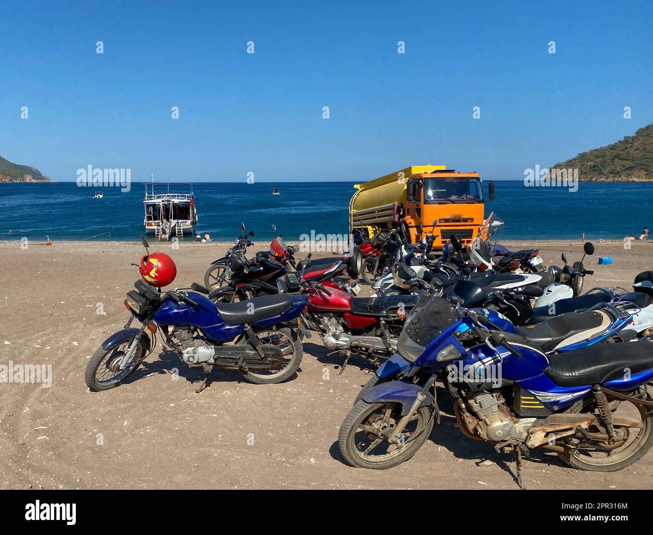 Motorcycles parked at the Vlychada Beach. Santorini Island, Greece ...