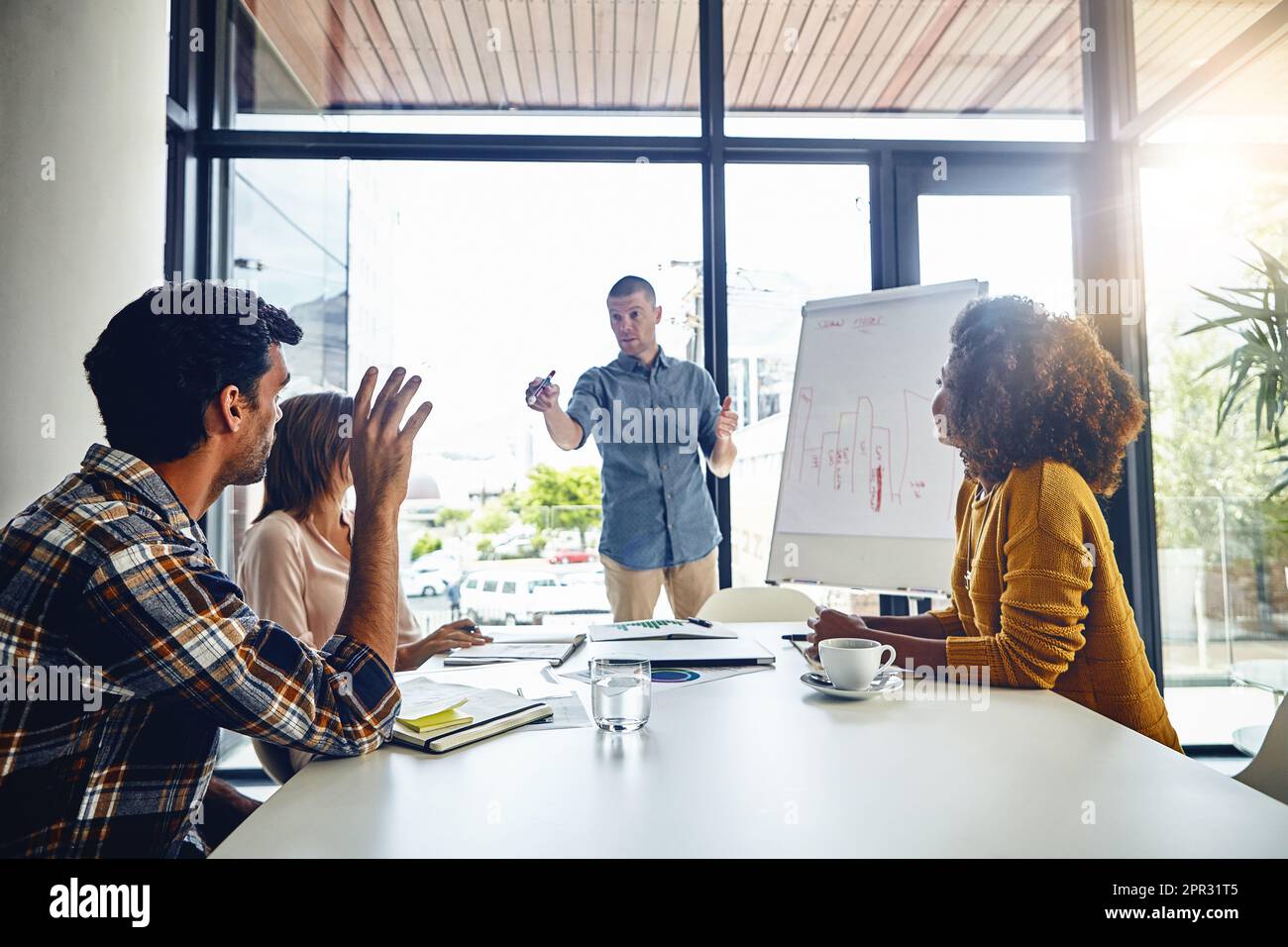 Giving everyone a chance to contribute. a businessman giving a ...