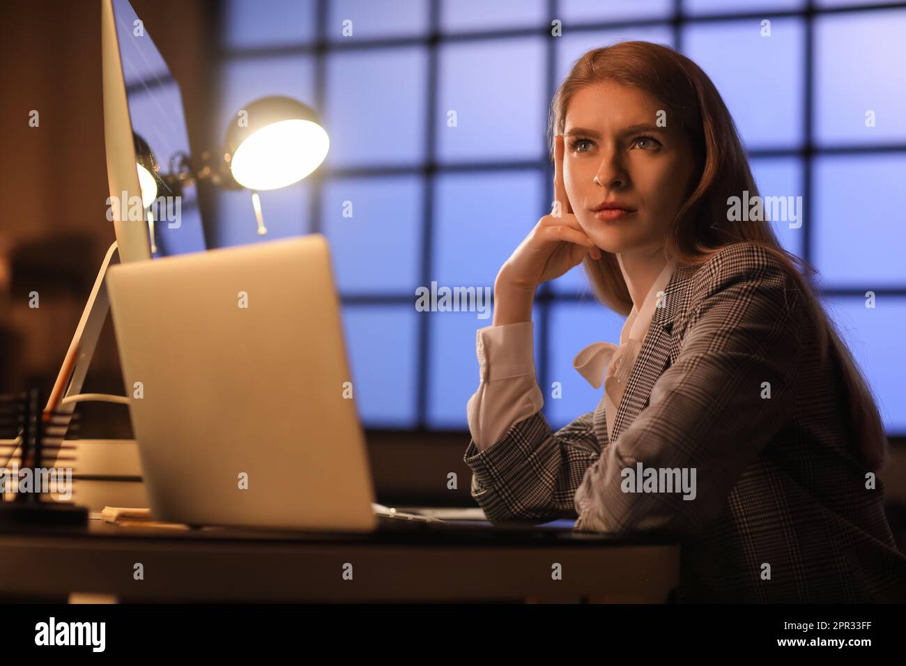 Female programmer working in office at night Stock Photo - Alamy
