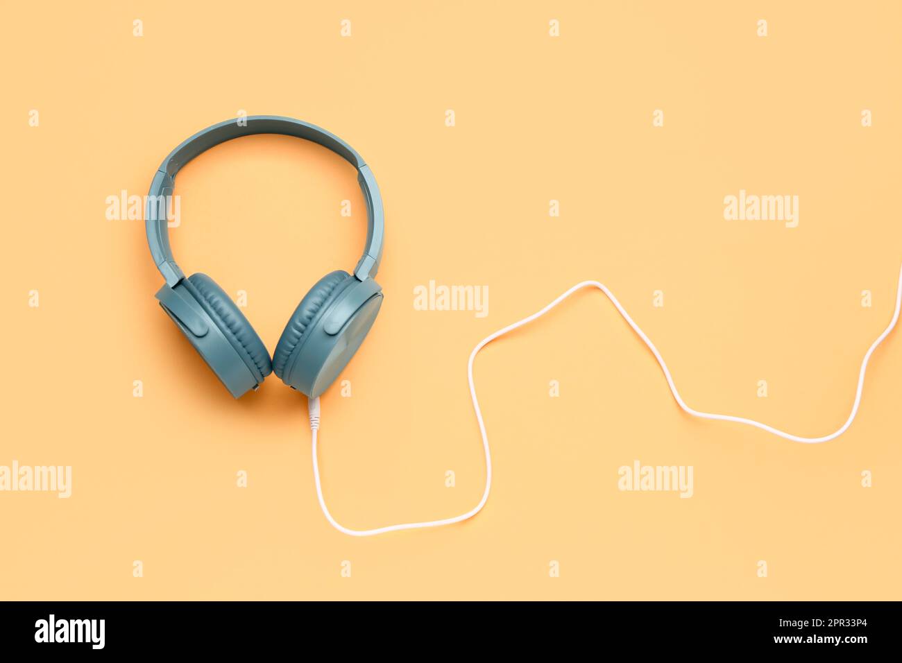 Modern blue headphones on beige background Stock Photo - Alamy