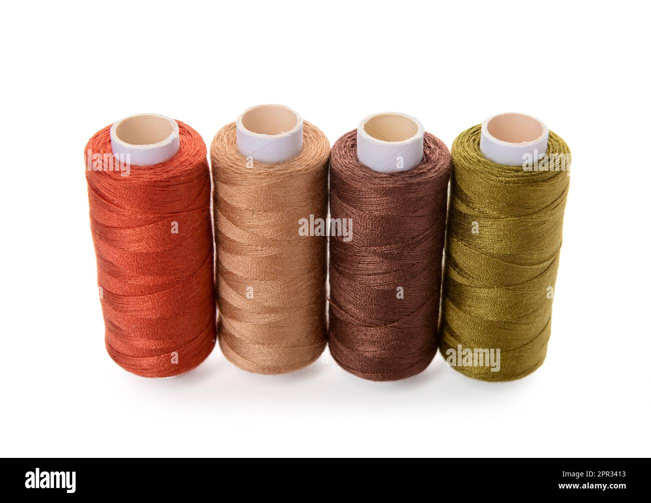Row of thread spools isolated on white background Stock Photo - Alamy