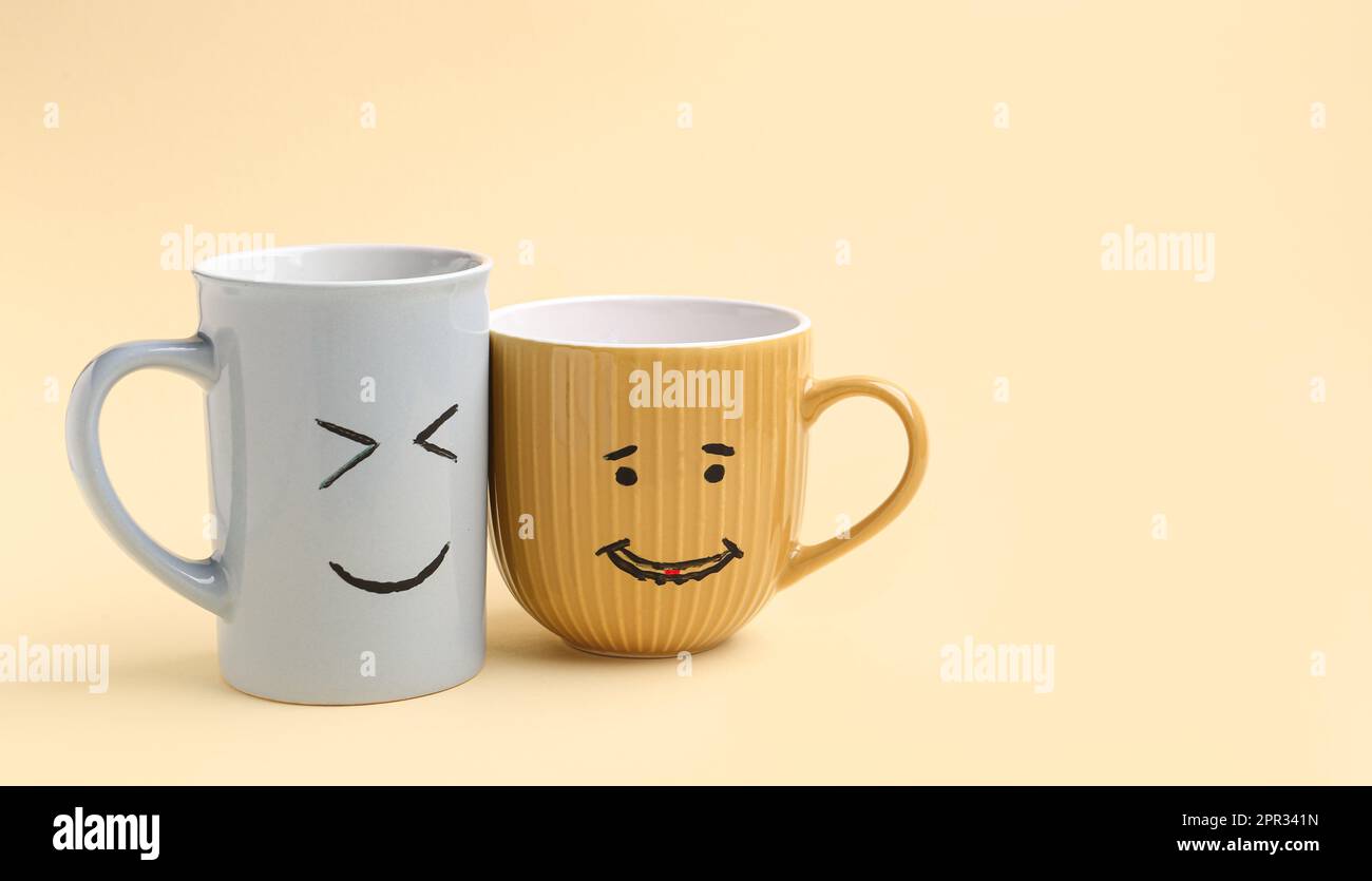 Cups with happy faces for Friendship Day on beige background Stock ...