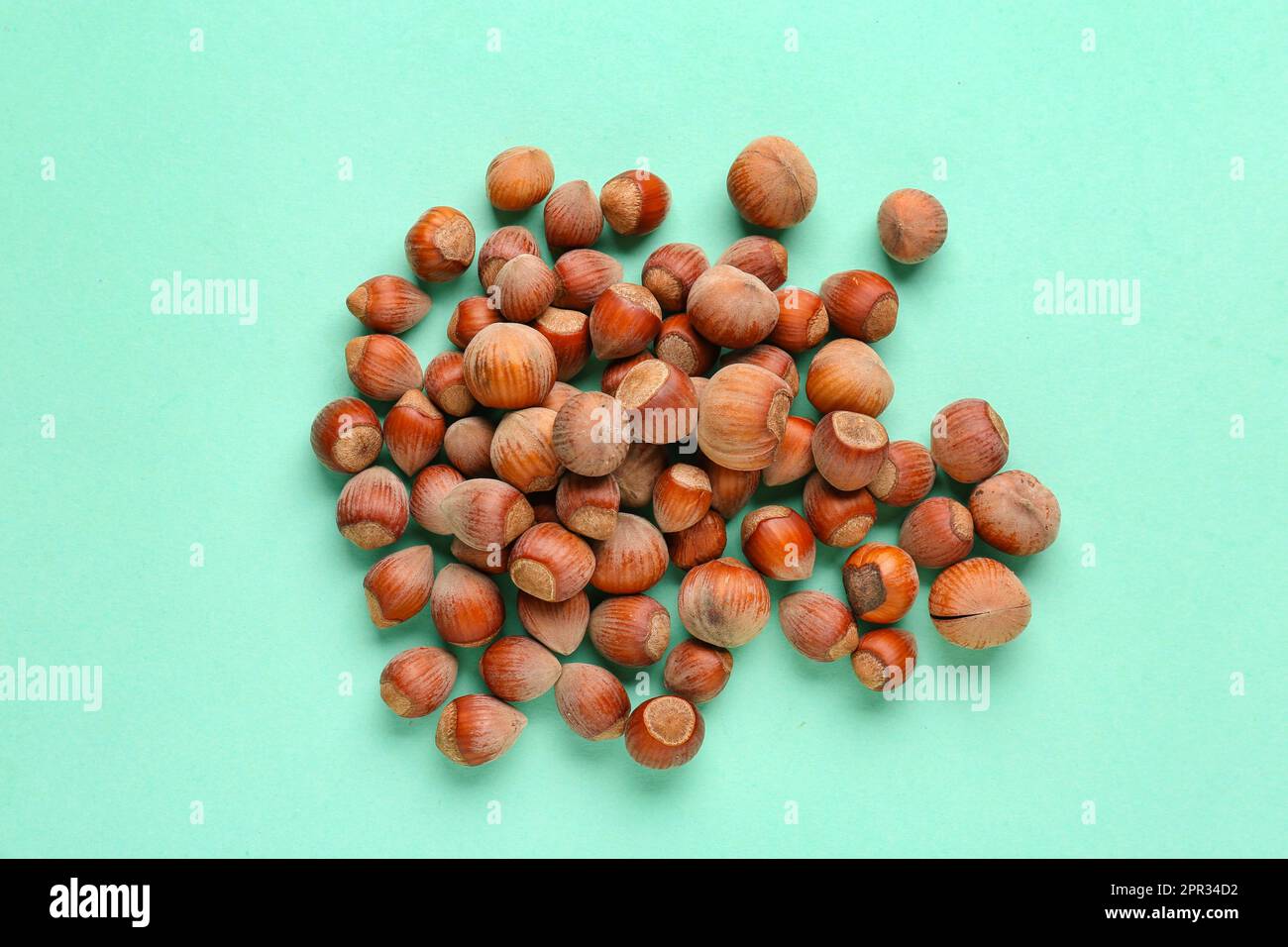 Shelled hazelnuts on blue background Stock Photo - Alamy