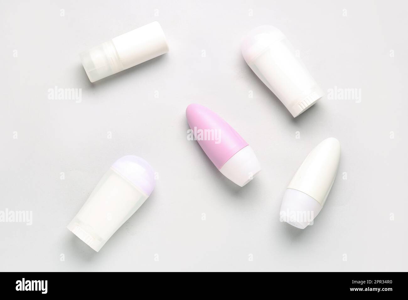 Different deodorant bottles on white background Stock Photo - Alamy