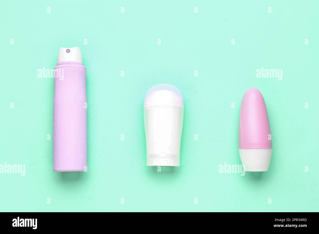 Different deodorant bottles on blue background Stock Photo - Alamy