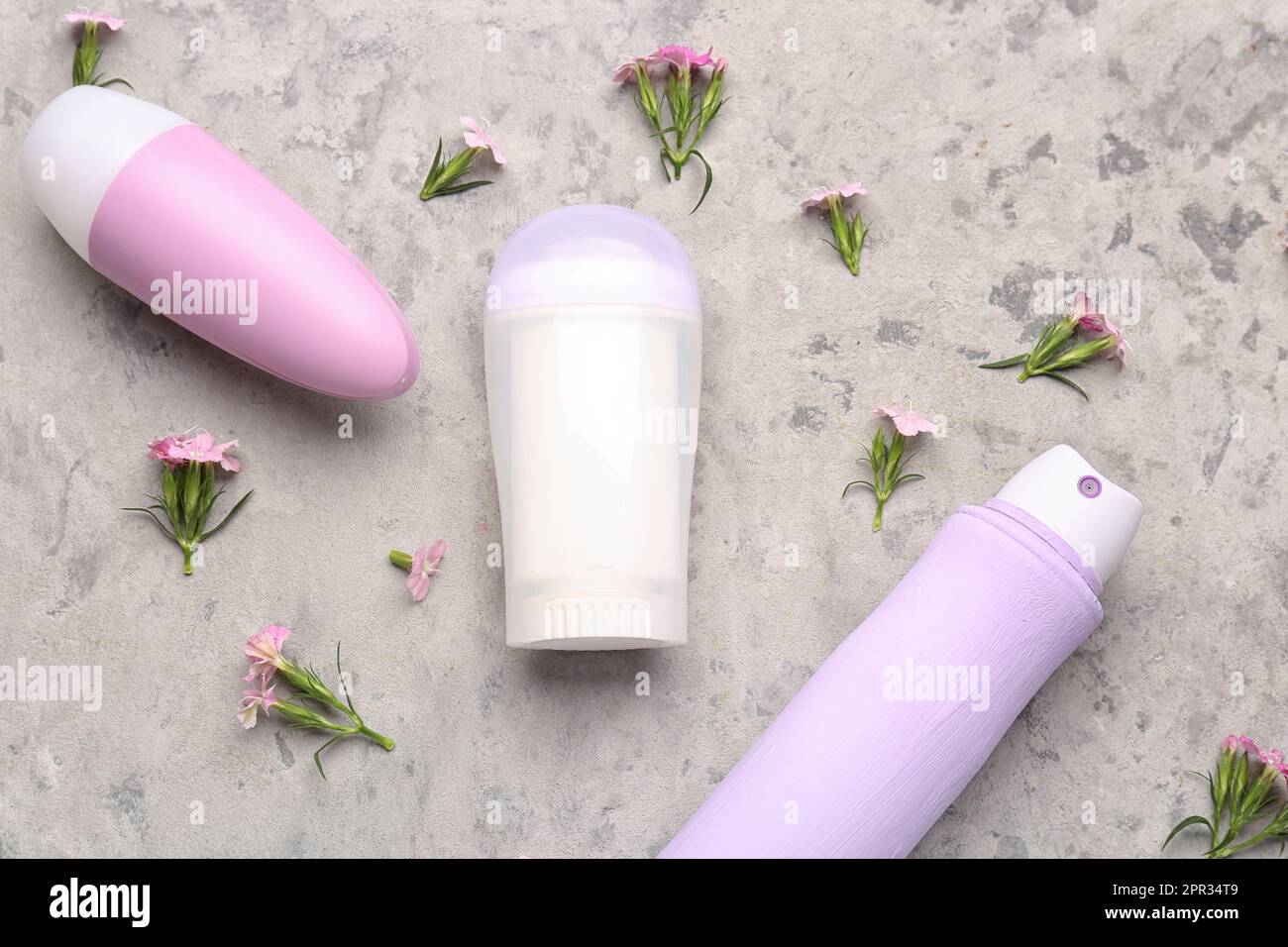 Different deodorants and flowers on grunge background Stock Photo - Alamy