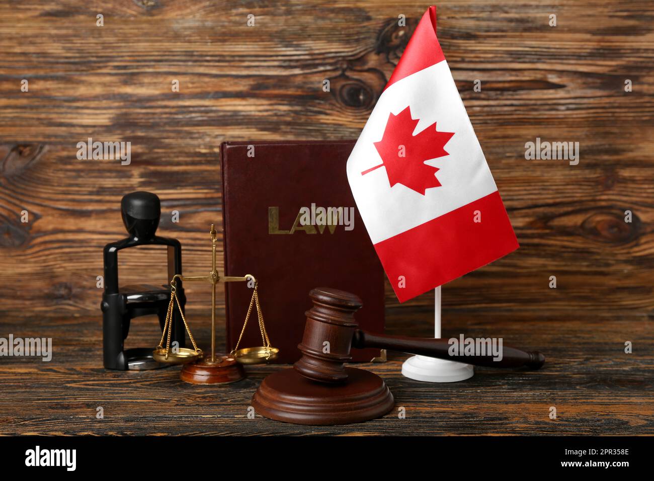 Flag of Canada, judge's gavel, justice scales, law book and stamp on ...