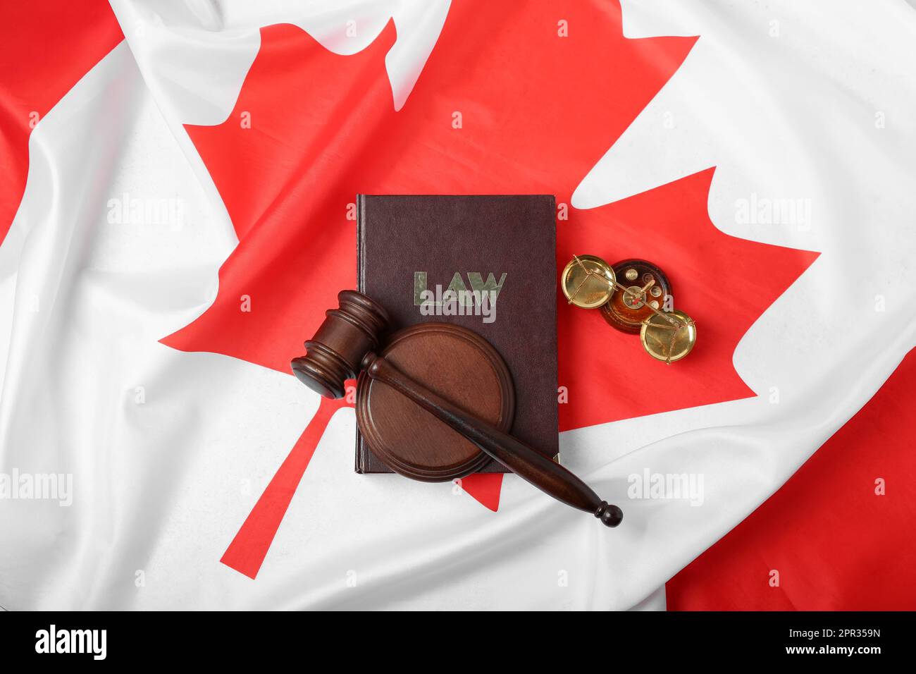 Judge's gavel with law book and justice scales on flag of Canada Stock ...